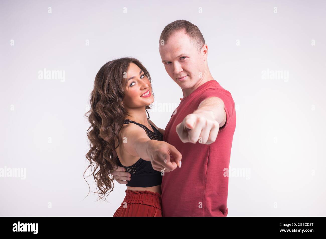 Portrait of young healthy sporty couple hugging on white background ...