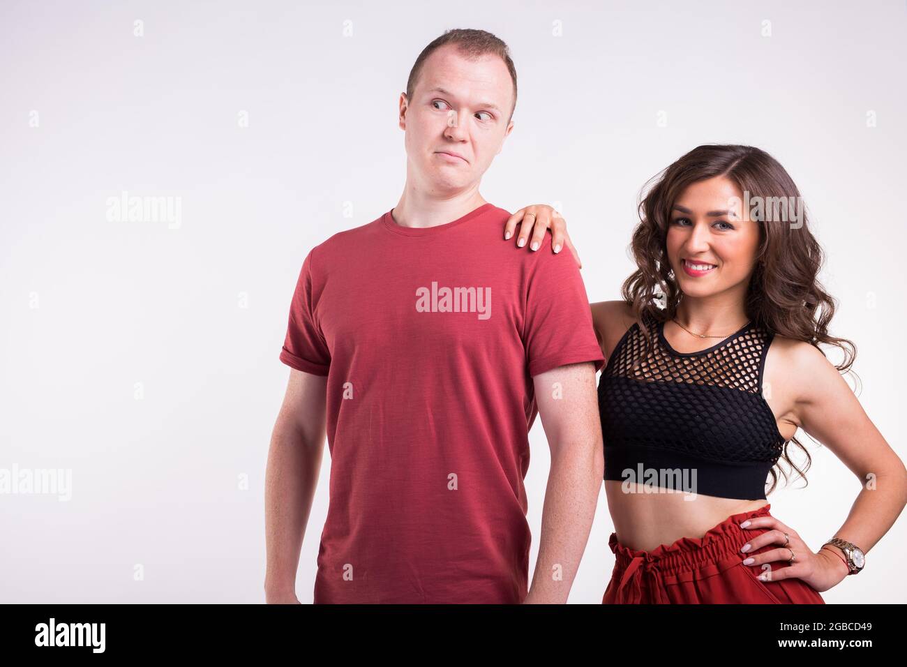 Portrait of young healthy sporty couple hugging on white background ...