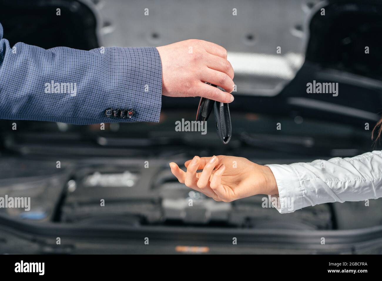 Man giving client keys to her repaired car in auto repair service Stock ...