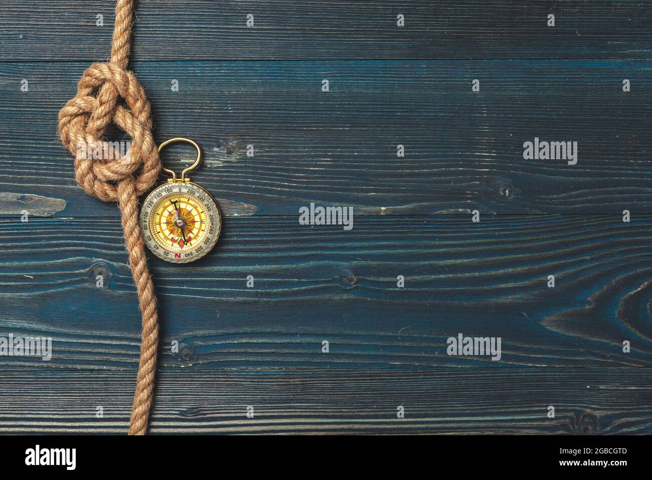 Nautical background. Sailing rope with a compass Stock Photo - Alamy
