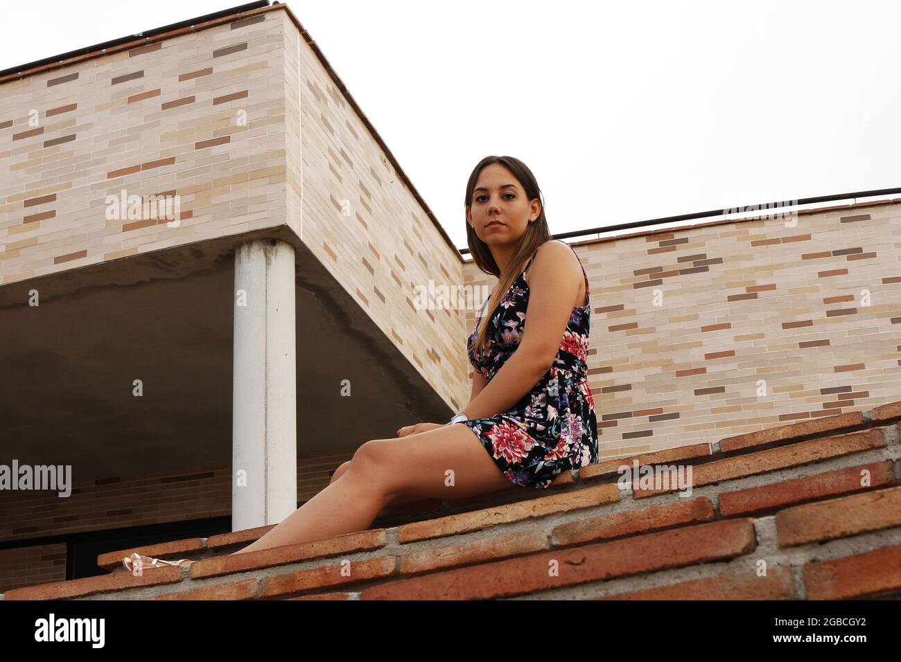 The girl looking at camera at amazing building Stock Photo - Alamy