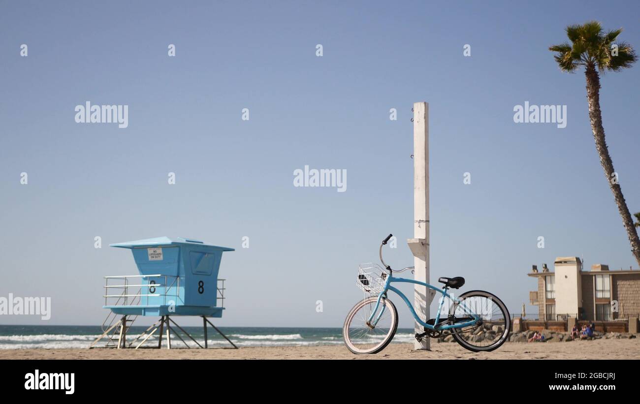 Blue bicycle, cruiser bike by ocean beach, pacific coast, Oceanside California USA. Summertime ...