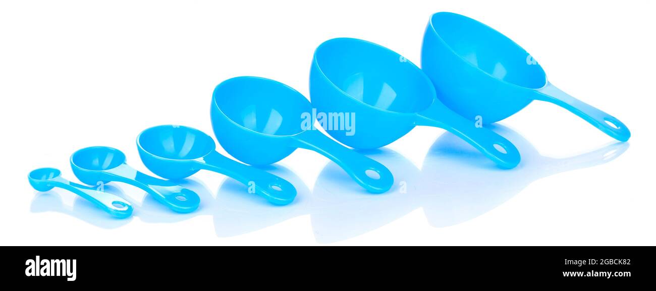 Blue measuring spoons isolated on white Stock Photo - Alamy
