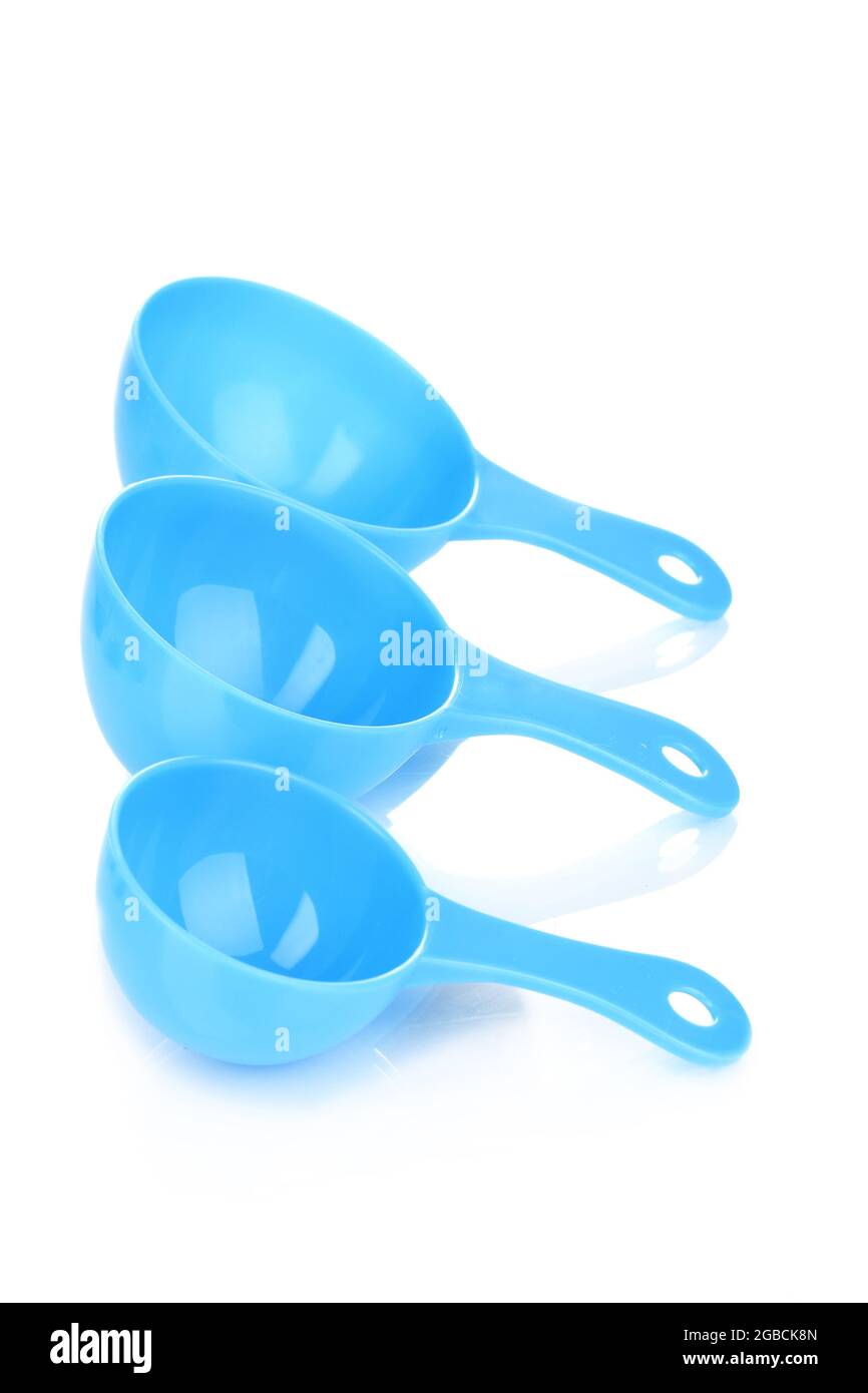 Blue measuring spoons isolated on white Stock Photo - Alamy