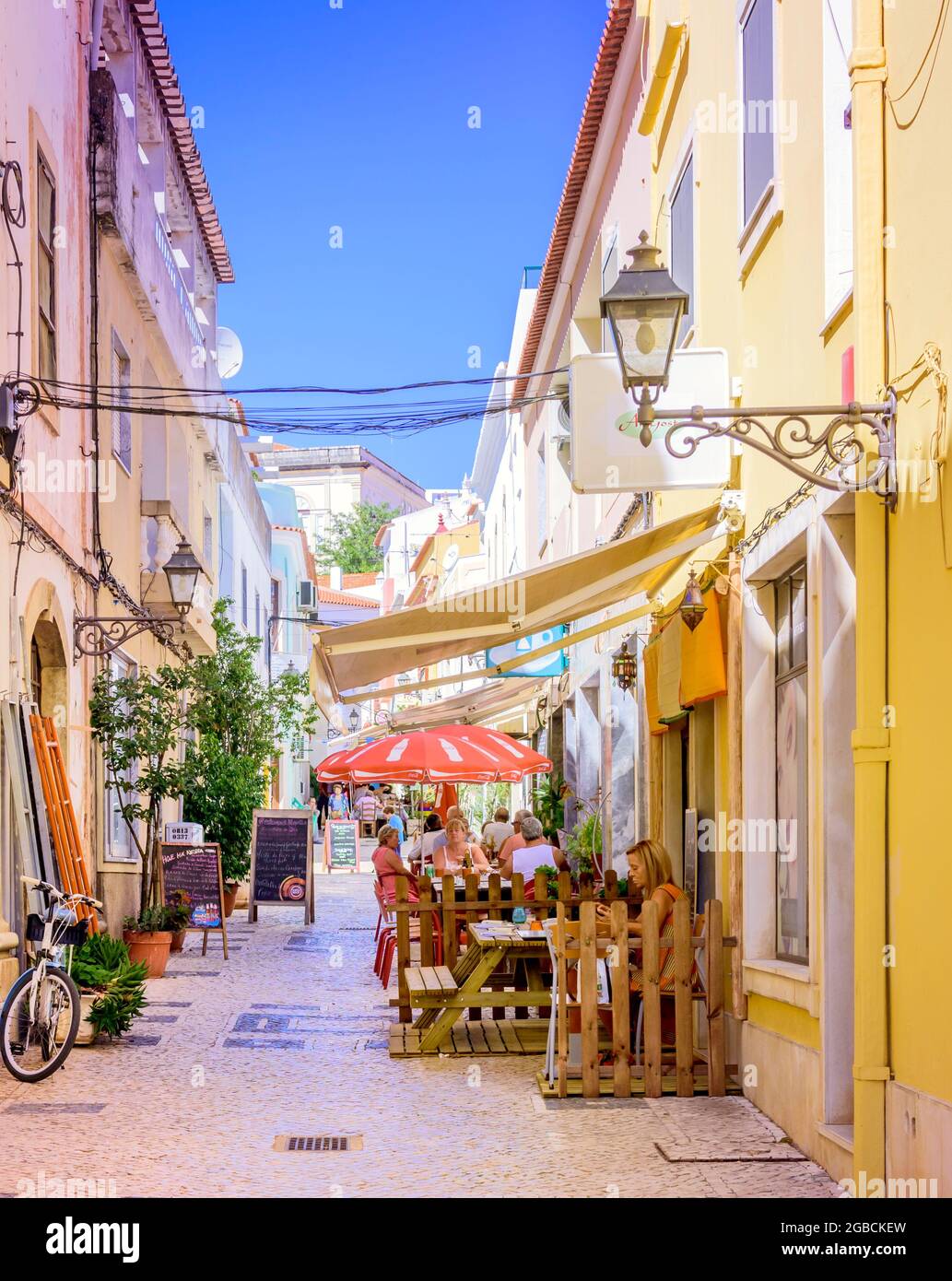 Street pavement restaurant cafe along traditional calcada cobbled ...