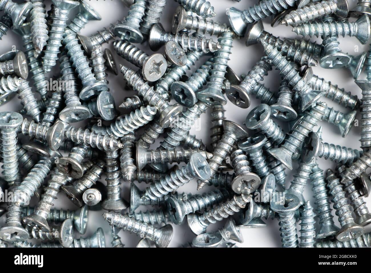 Metal screws on a white background. Set of building tools for repair ...