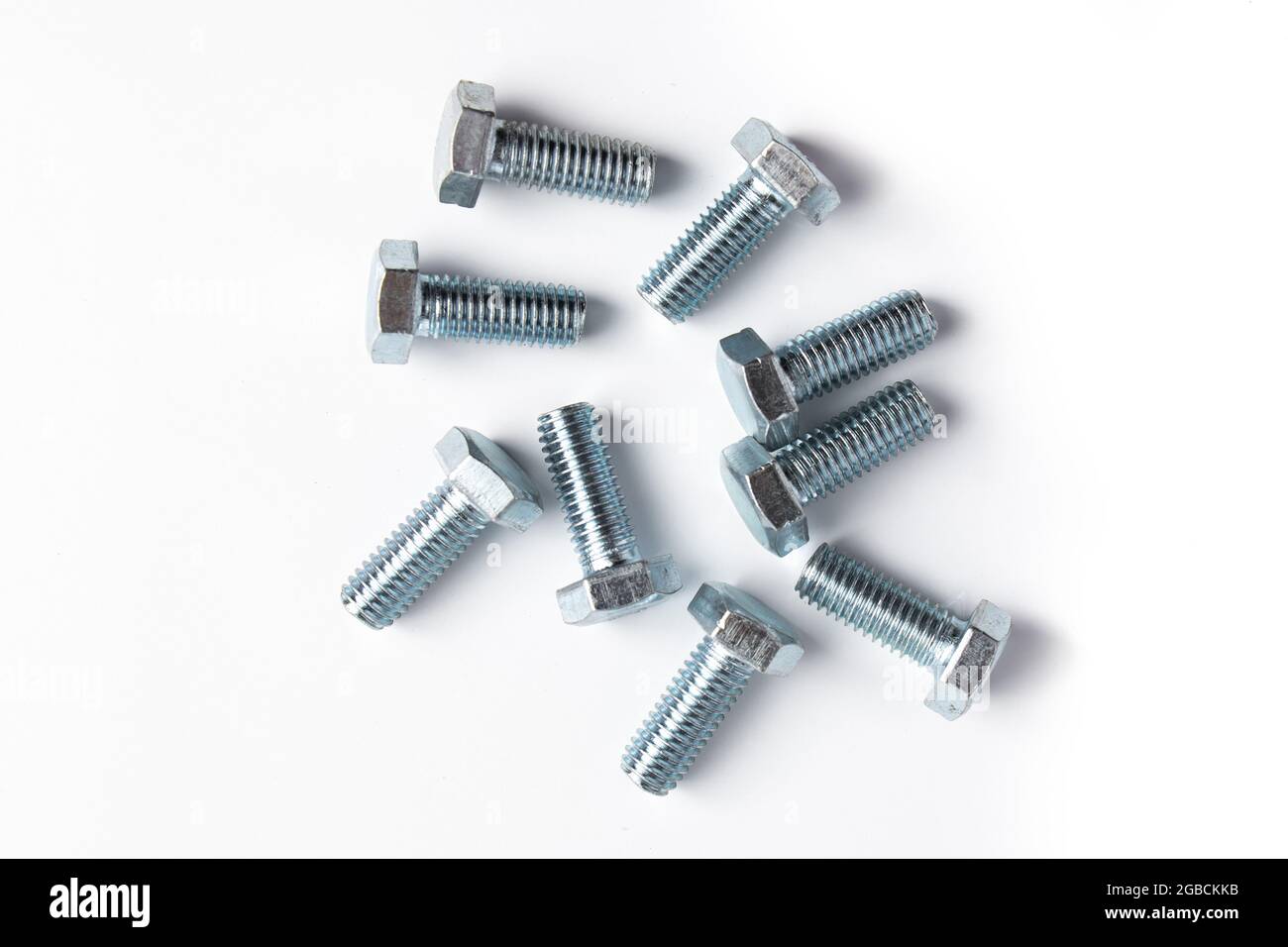 New metal bolts on a white background. Set of building tools for repair ...
