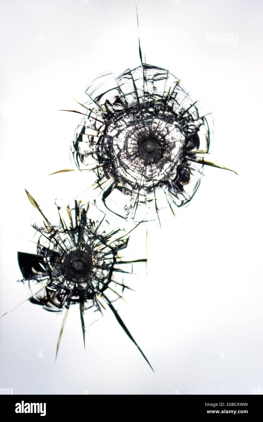 Cracks on the glass from gun shots. Broken shop window after a criminal ...