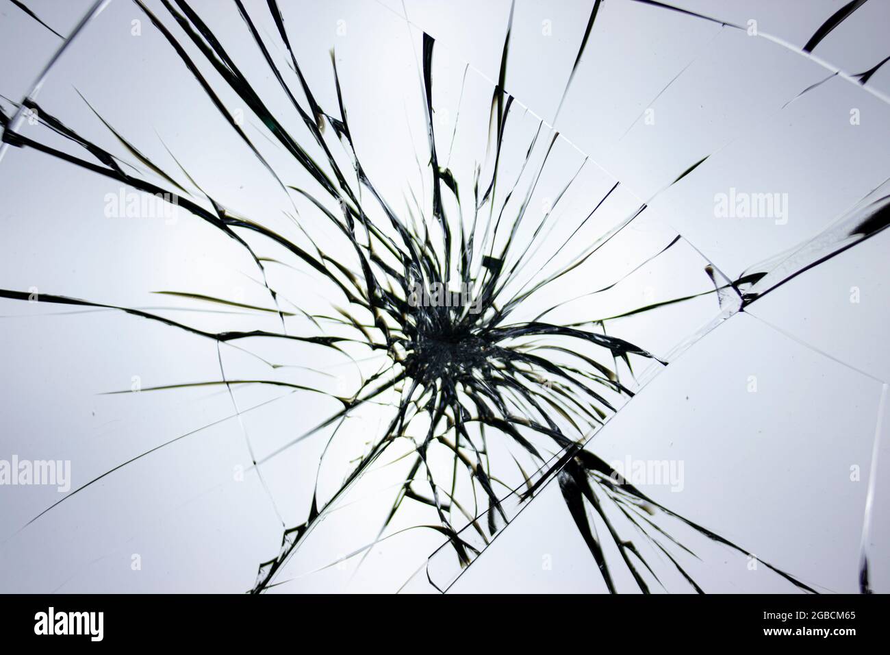 Crack lines of broken glass. The texture of the impact and the ...