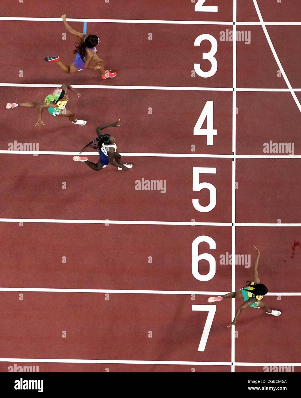 Jamaica's Elaine Thompson-Herah (bottom) crosses the finish line to win ...