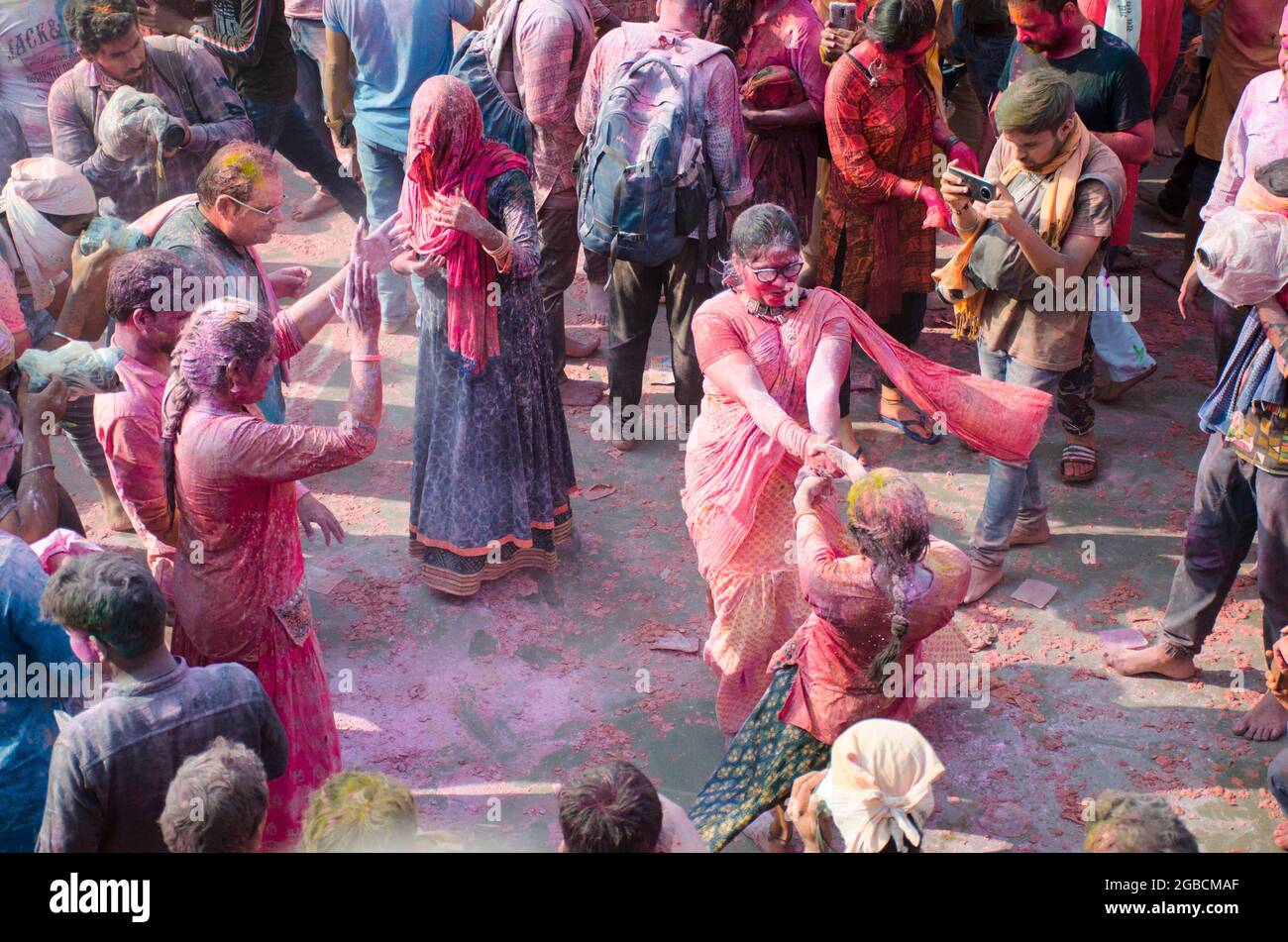 Ladies are spinning while dancing in joy, celebrating the Holi festival ...