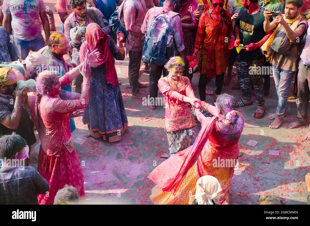 Ladies are spinning while dancing in joy, celebrating the Holi festival ...