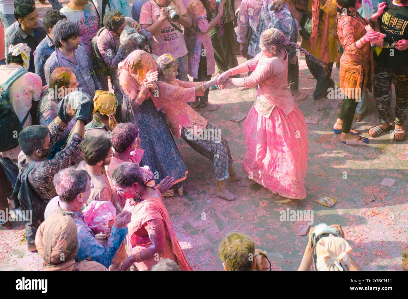 Ladies are spinning while dancing in joy, celebrating the Holi festival ...