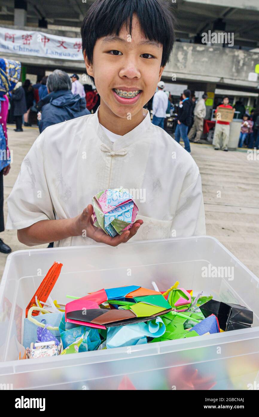 Asian teen teenager student boy selling origami folded paper ornaments ...
