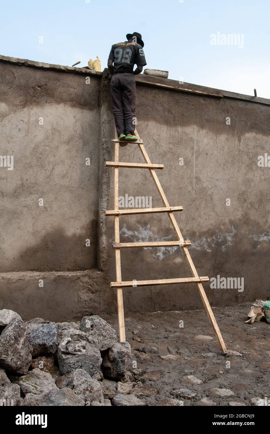 man at work over a crooked staircase Stock Photo - Alamy