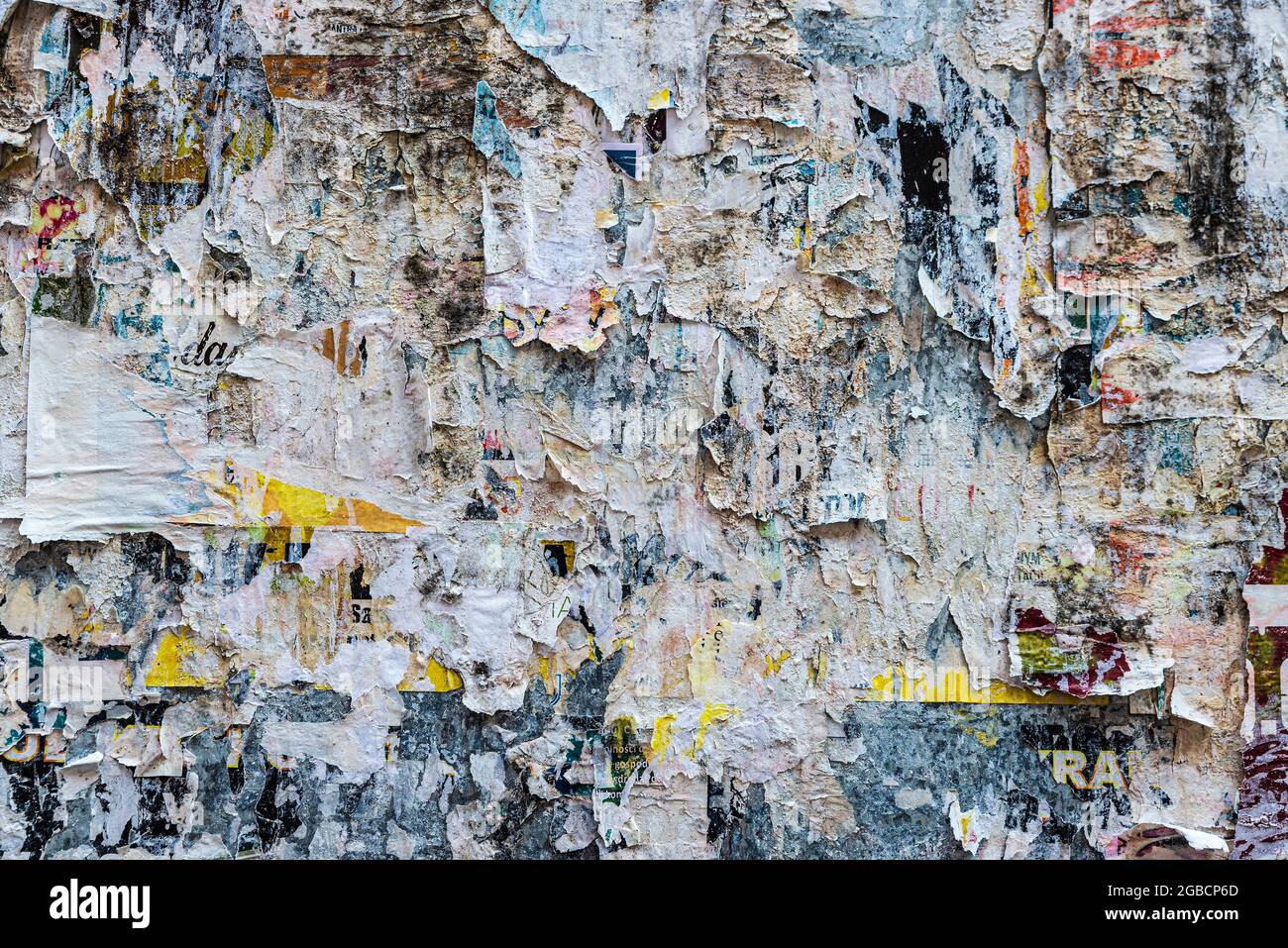 Collage of poster scraps pasted on a wall as background in Krakow ...