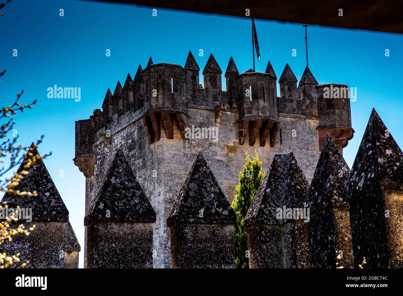 Stone walls and large square towers with defensive walkways at the top ...