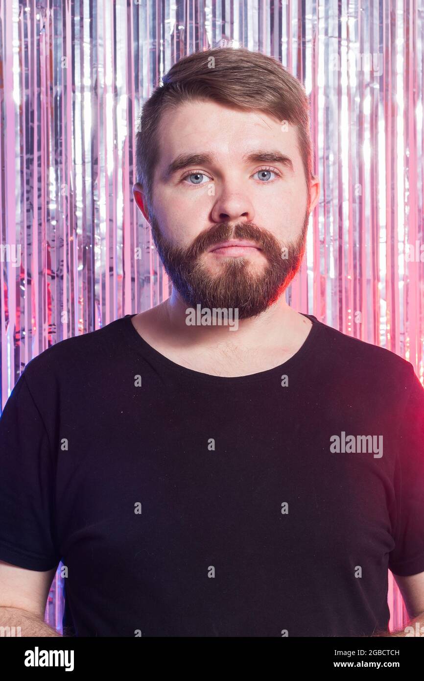 Party, carnival, holidays and emotional concept - Sad man against shiny ...