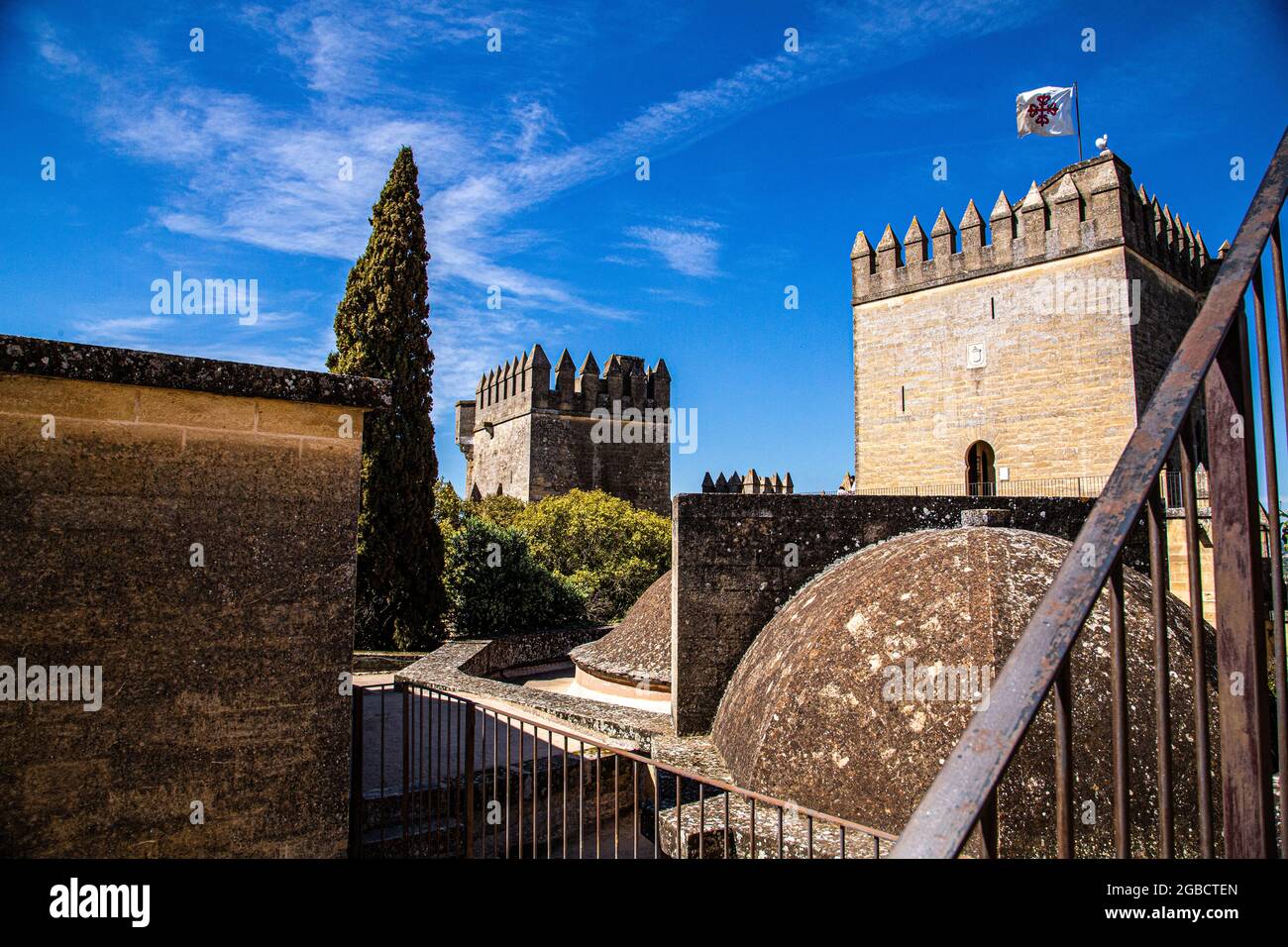 Stone walls and large square towers with defensive walkways at the top ...