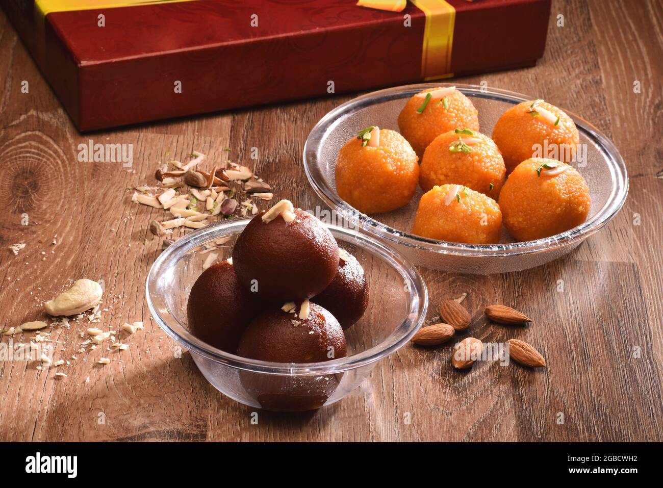 diwali sweets concept, ladoo and gulab jamun on wooden table with ...