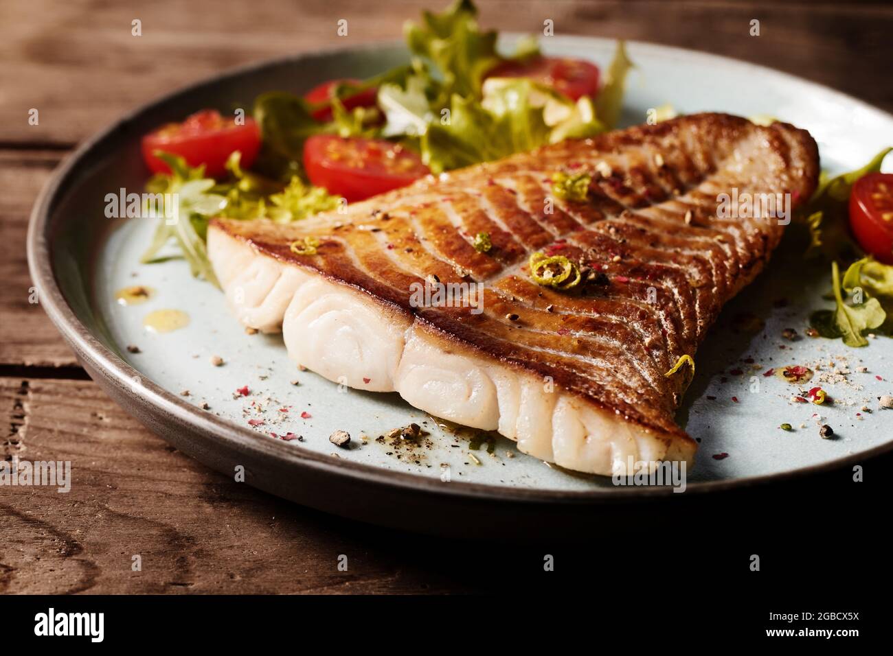 High angle of delicious fried pollock fish served with lettuce leaves ...