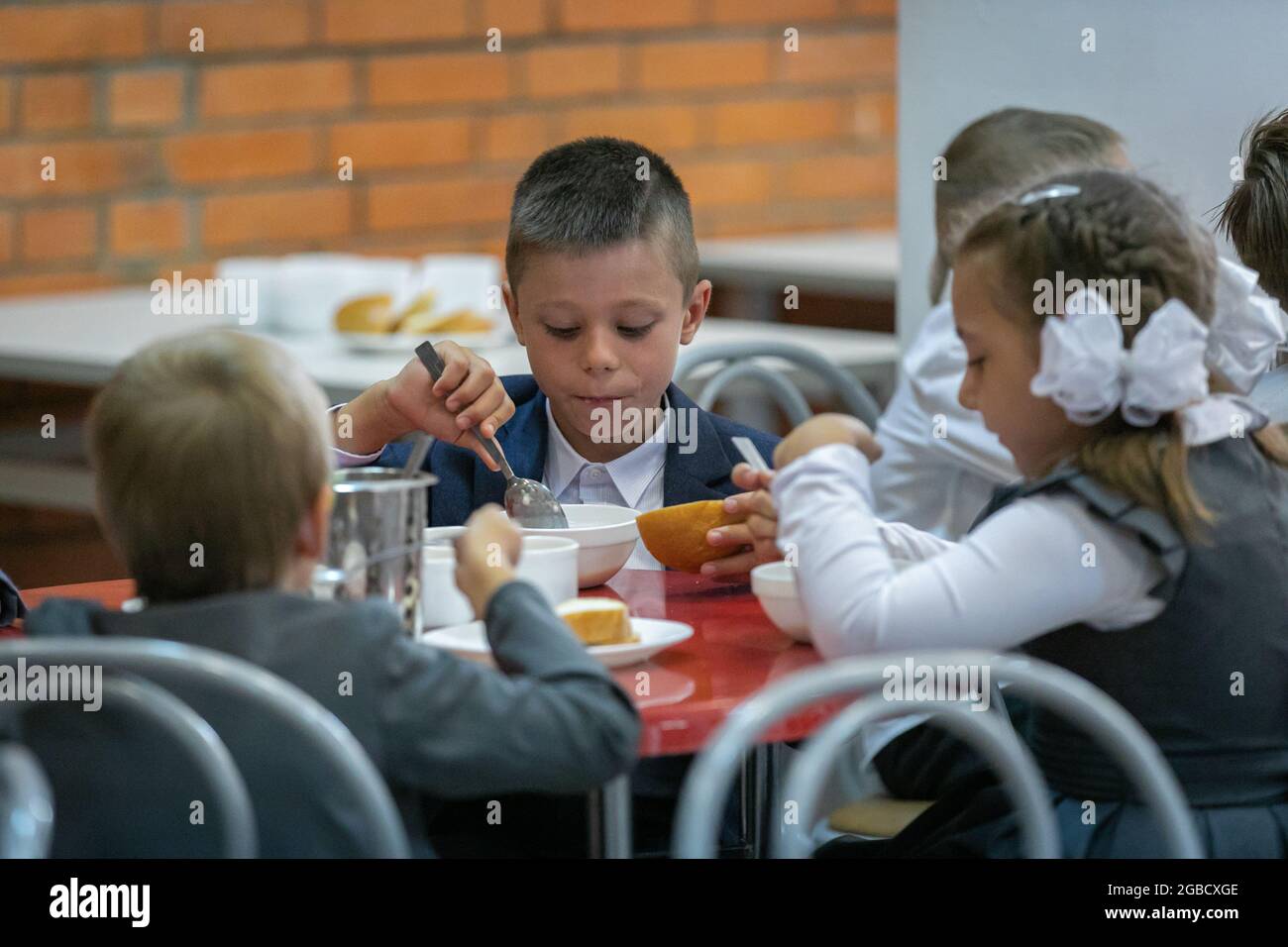 First graders eat in the school cafeteria. Lunch in the dining room on ...
