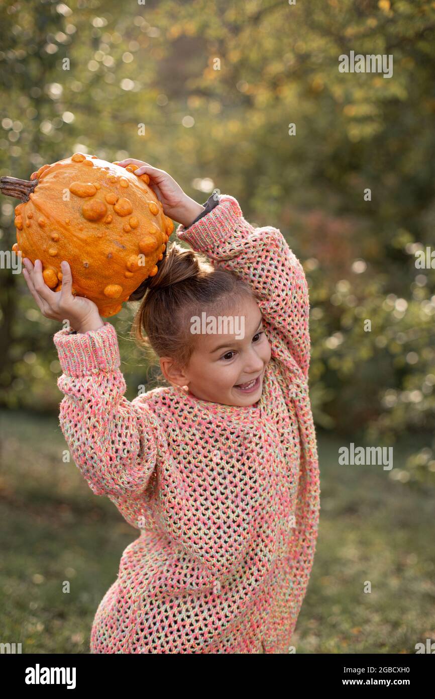 Deformed ugly orange pumpkin in a child hands Stock Photo - Alamy