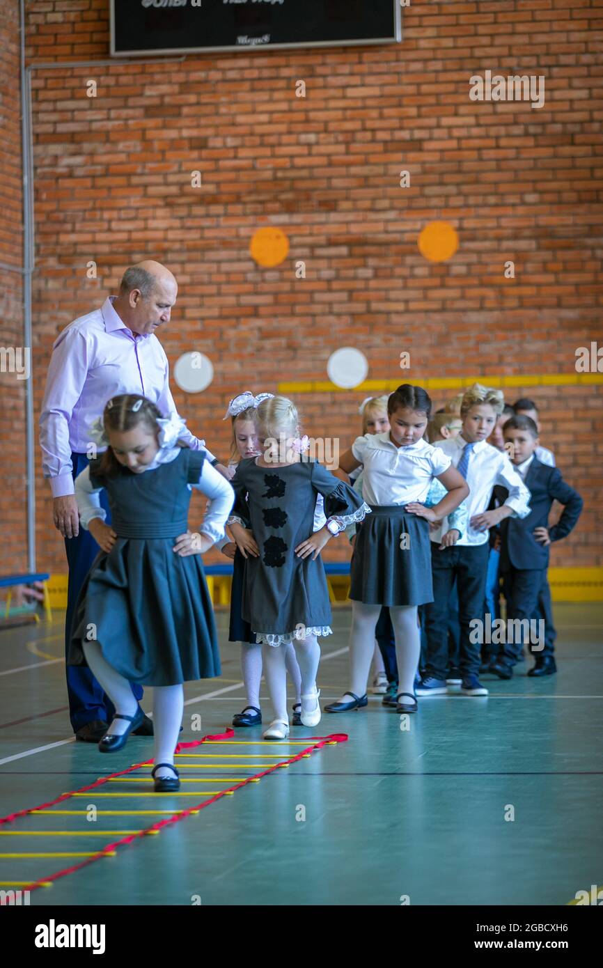First graders in their first physical education class at the gym. The ...