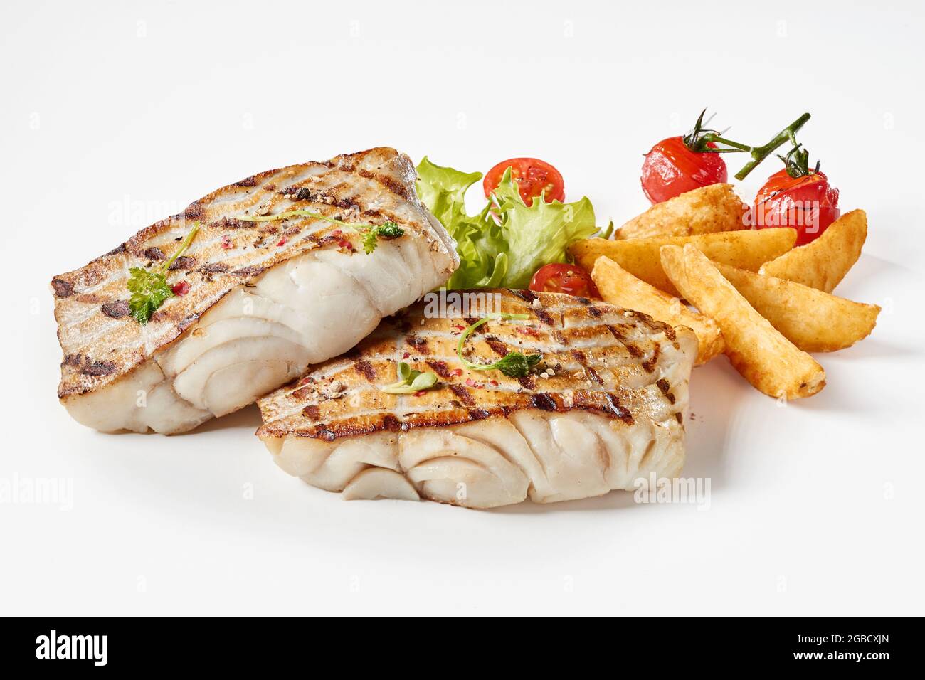 Delicious roasted fillet of pollock served with fried potatoes and ...