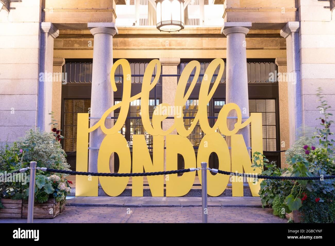 big lettering of greeting HELLO LONDON lit up at night in Covent Garden ...