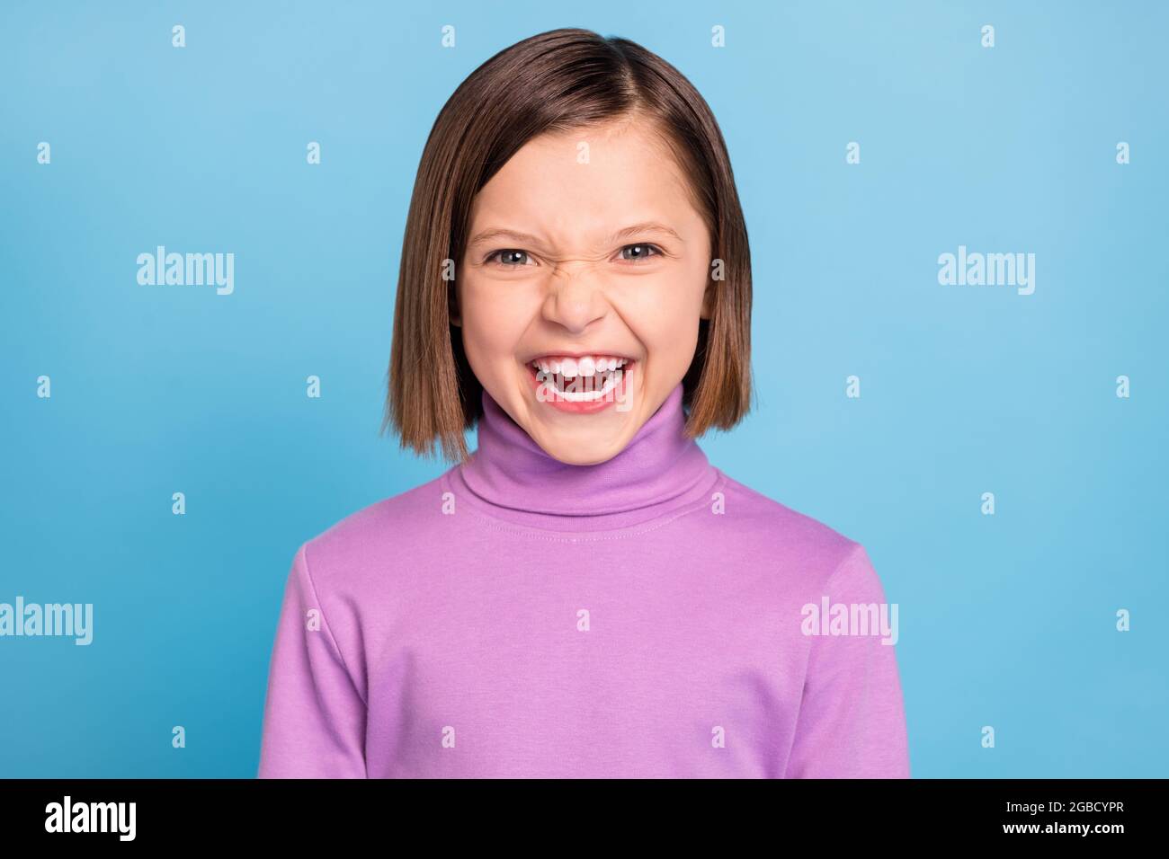 Photo of playful funky school girl wear purple turtleneck showing teeth ...