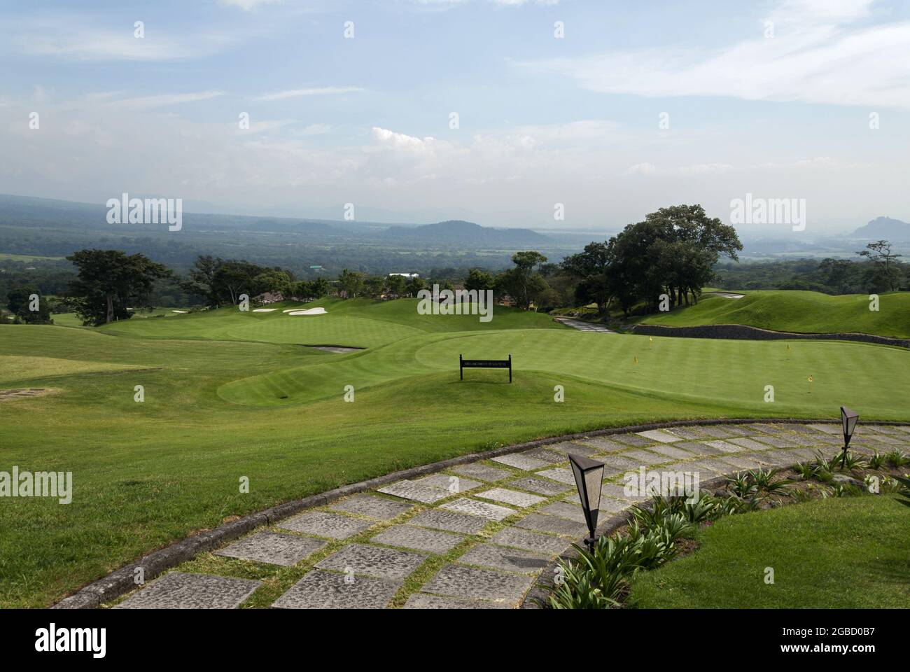 Beautiful golf course illuminated with sunlight Stock Photo - Alamy