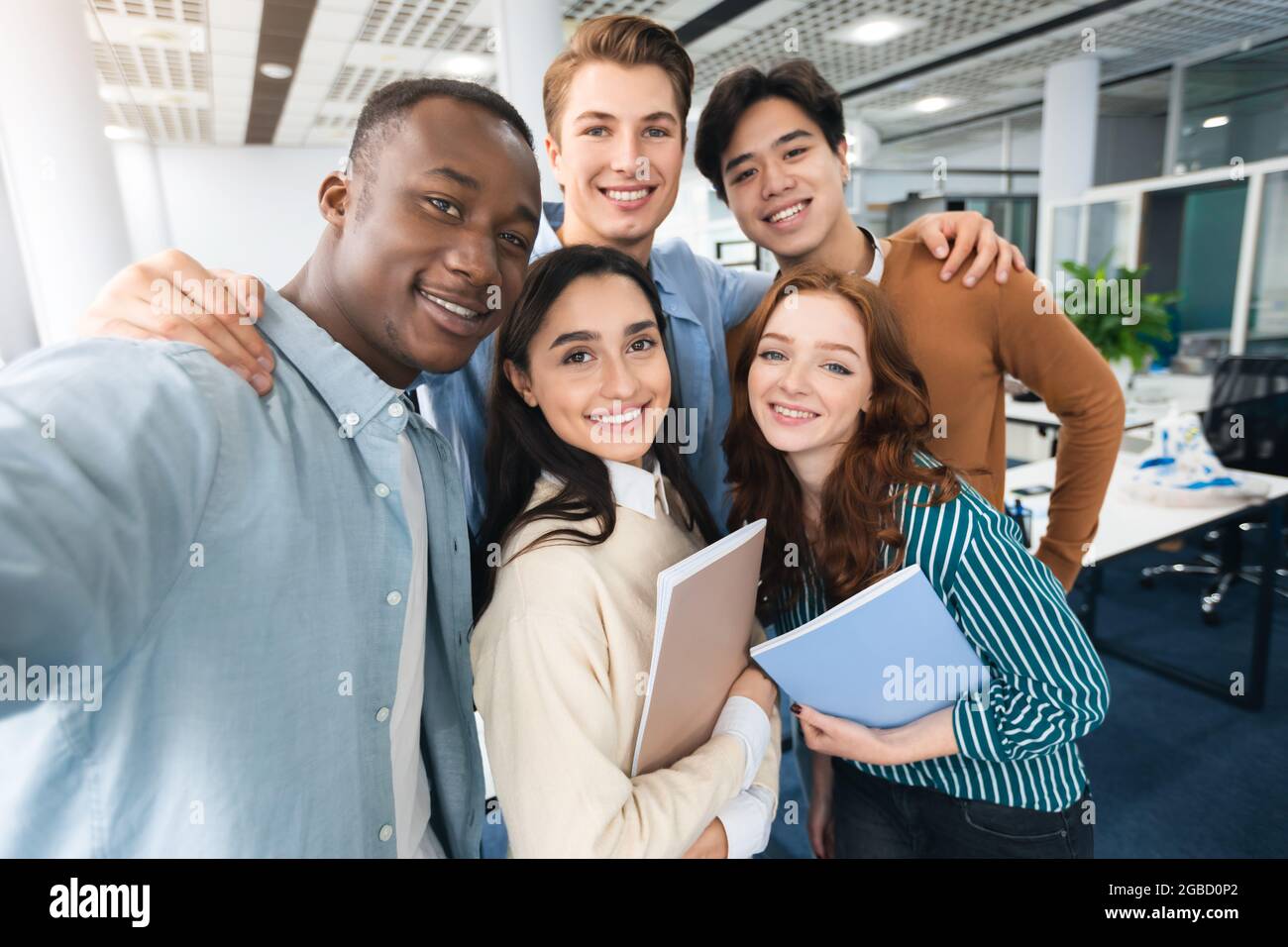 Happy international students taking selfie in university Stock Photo ...