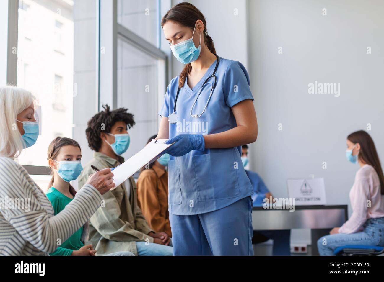Senior Patient Lady Signing Papers With Doctor In Hospital Stock Photo ...
