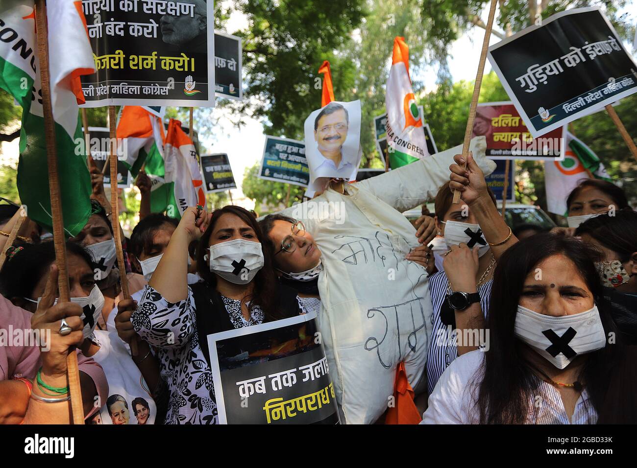 Delhi, India. 03rd Aug, 2021. Protesters wearing crossed out face masks ...