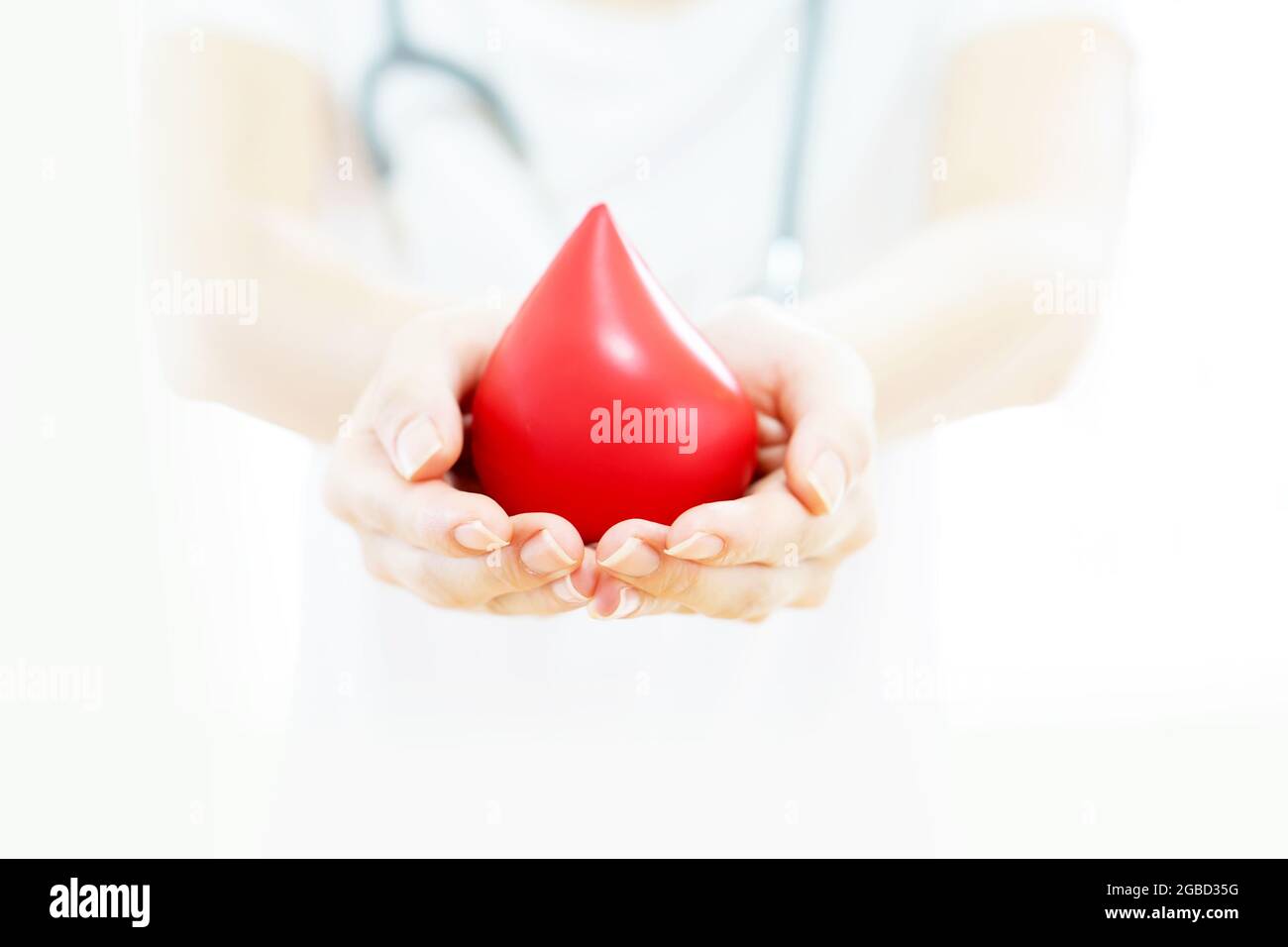 Doctor hands holding a red blood Stock Photo - Alamy