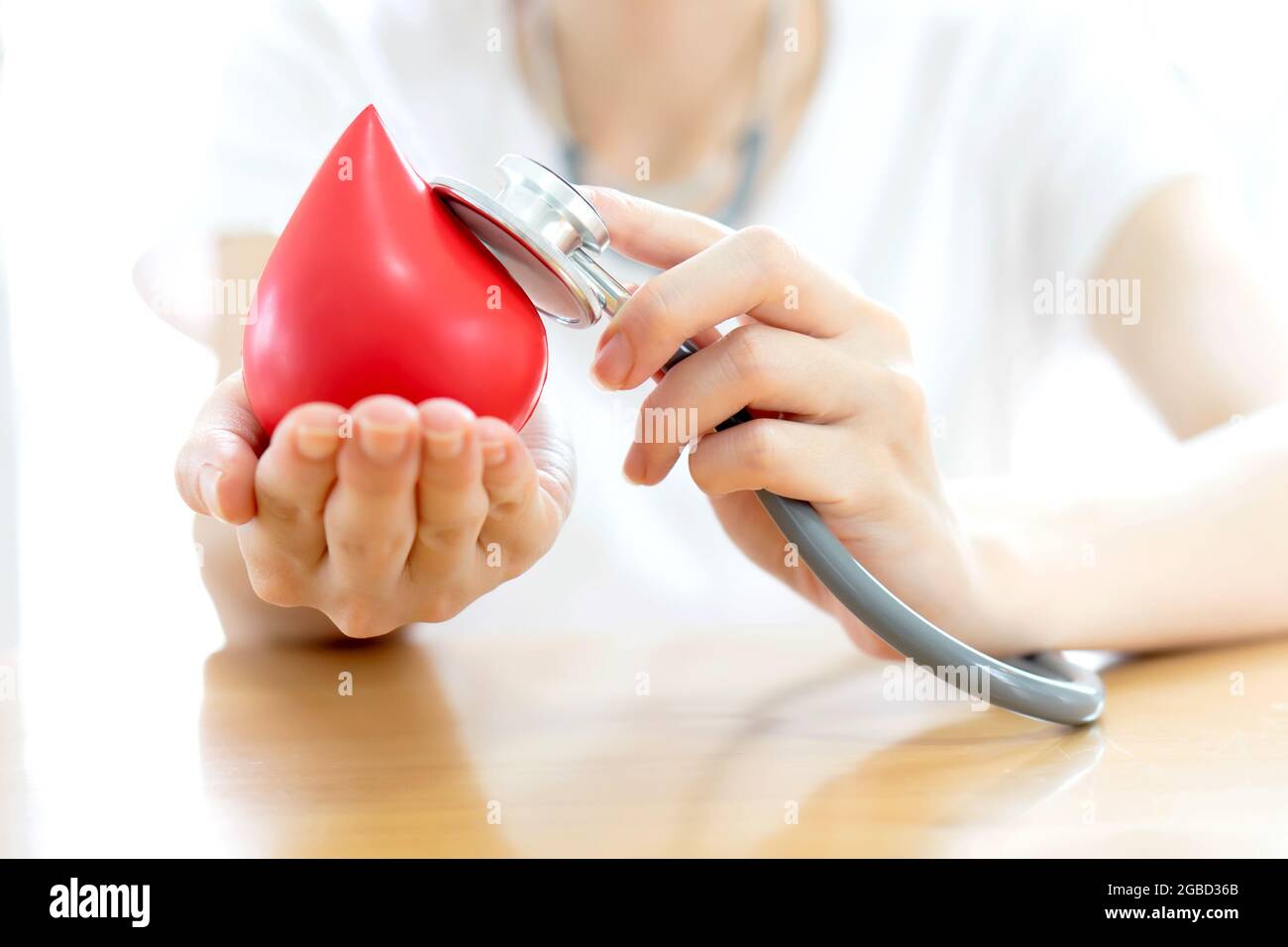 Doctor hands holding a red blood Stock Photo - Alamy