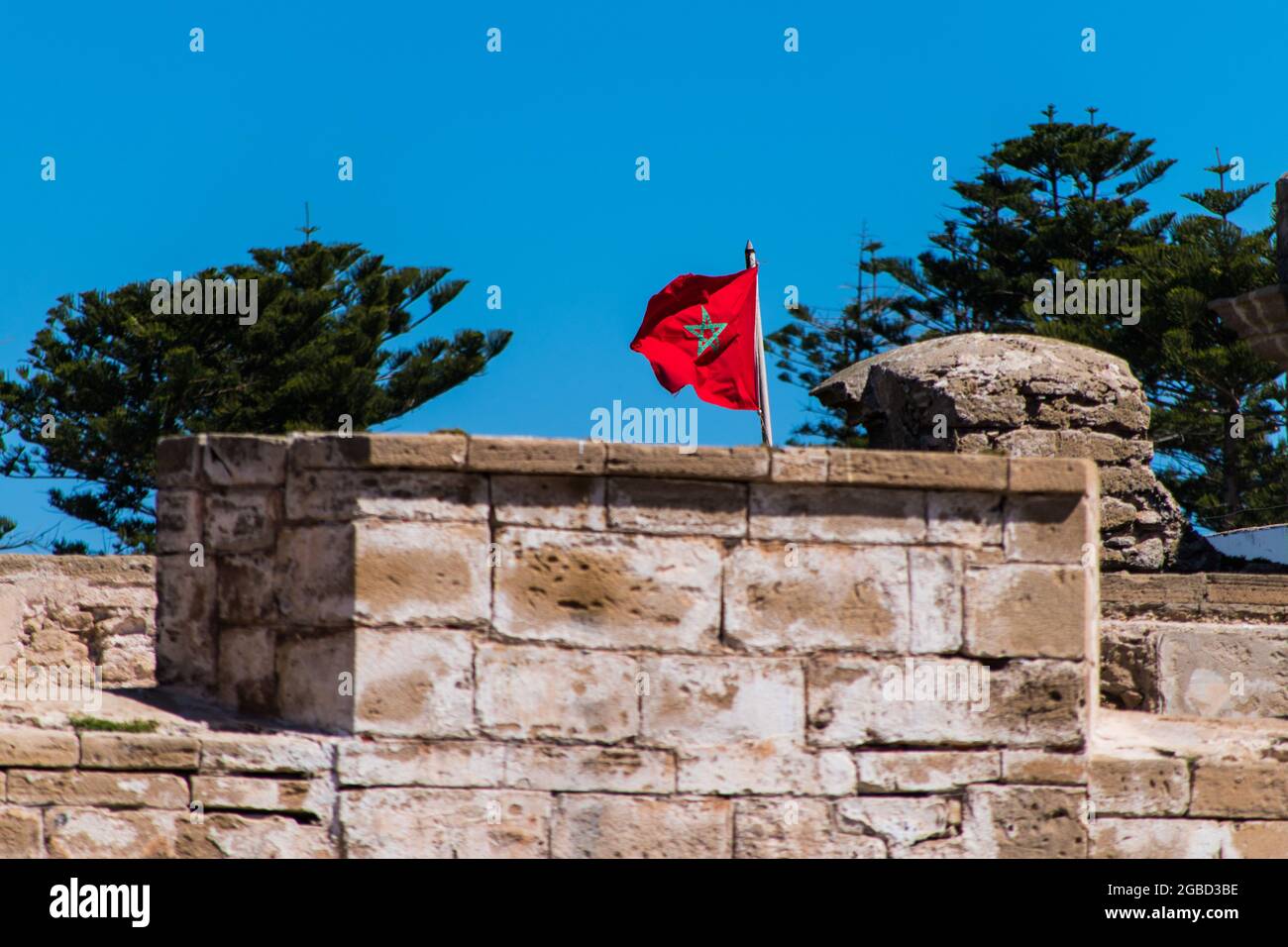 Flag of Morocco waving on the stone wall (Essaouira, Morocco Stock ...