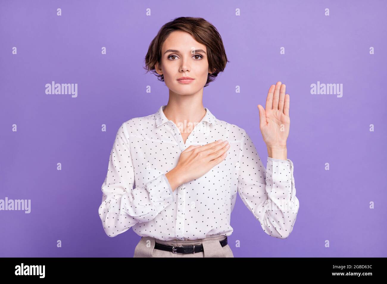 Portrait of young girl concentrated face arm on heart look camera ...