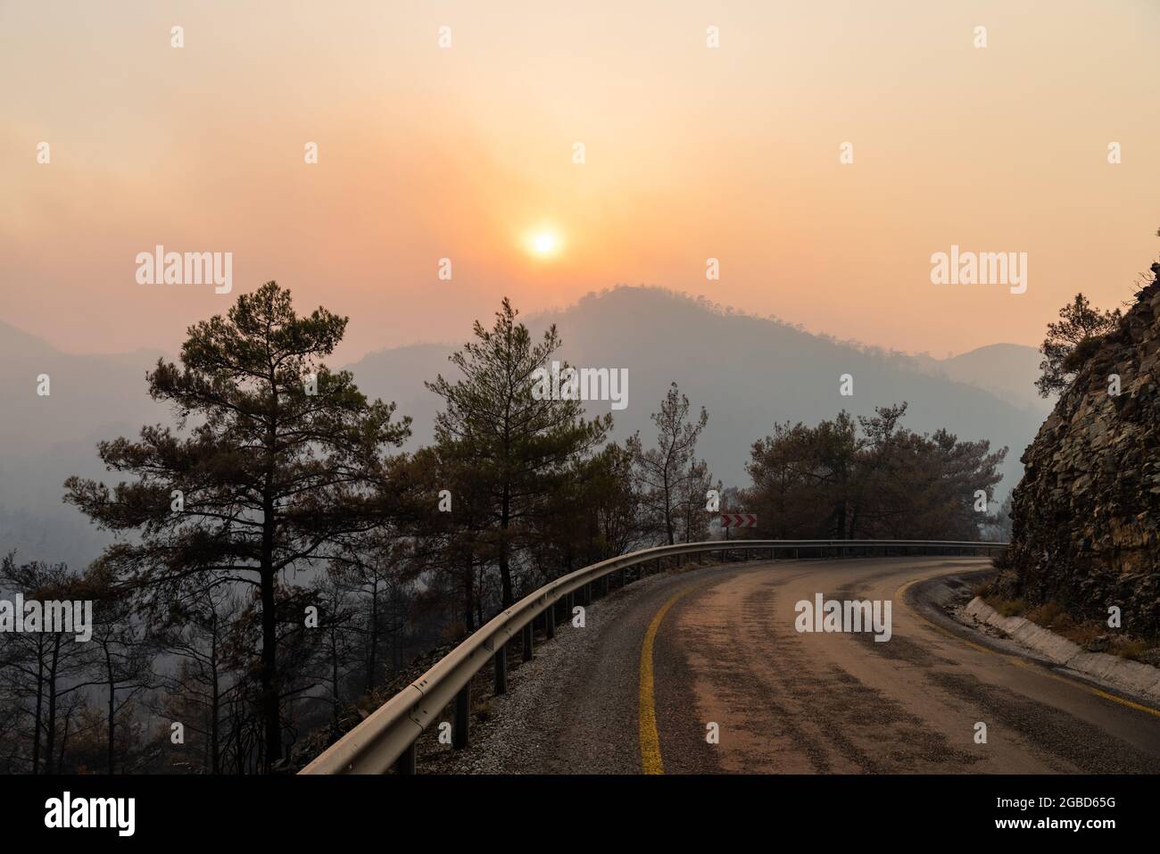 Sun shining through a cloud of smoke on Icmeler-Hisaronu road ...