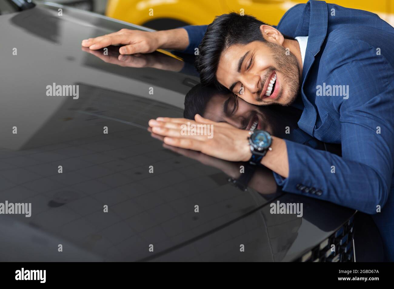 Delighted arab man hugging car of his dream Stock Photo - Alamy