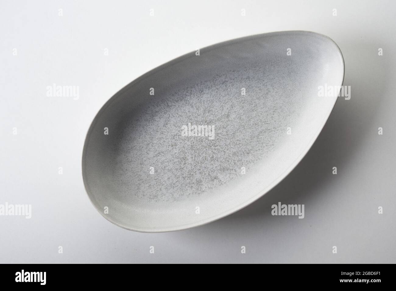 Top view of elegant oval shaped light gray ceramic serving platter on ...