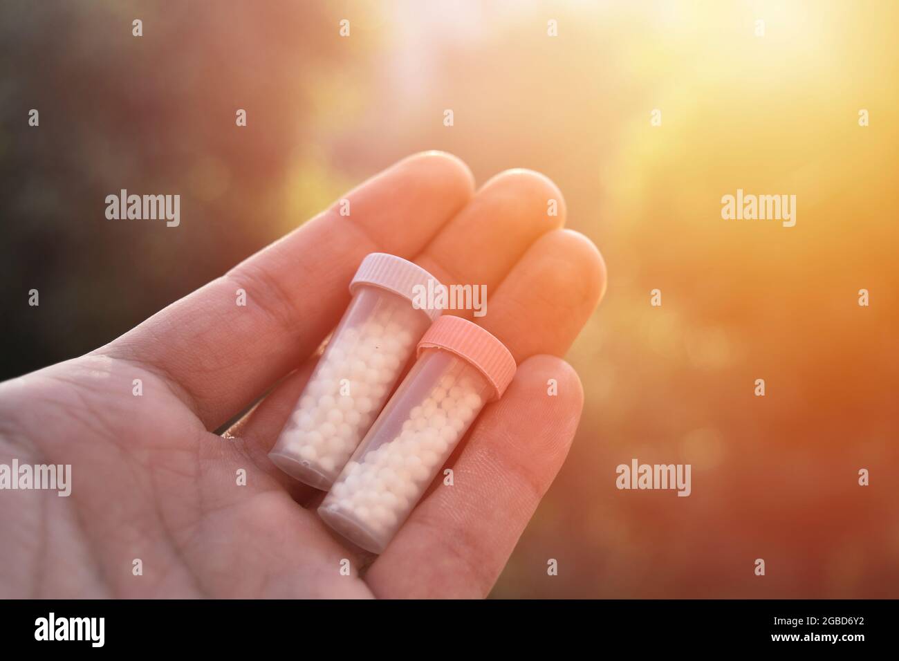 Container of Homeopathic Tablet in Hand Stock Photo - Alamy
