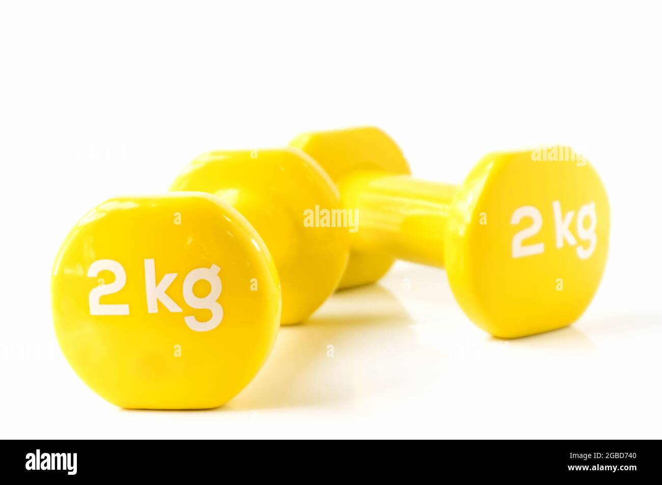 Light yellow dumbbell weight in white background Stock Photo - Alamy