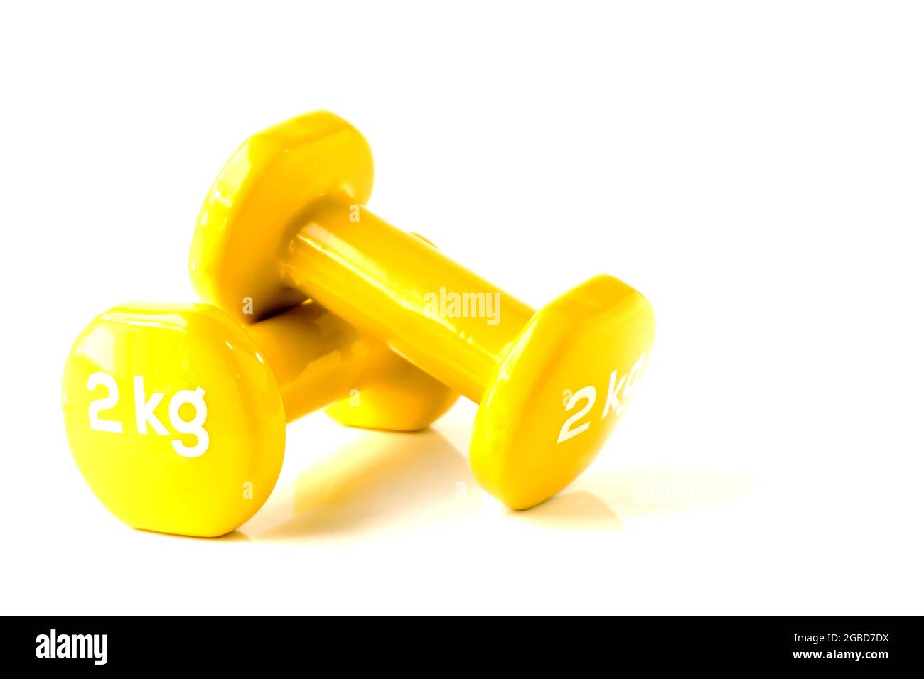 Light yellow dumbbell weight in white background Stock Photo - Alamy