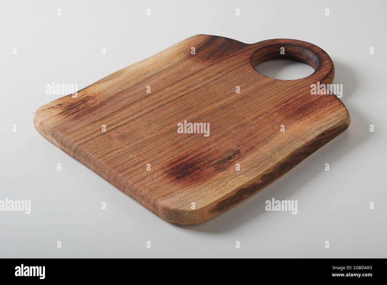 From above of smooth wooden chopping board with burnt surface placed on ...