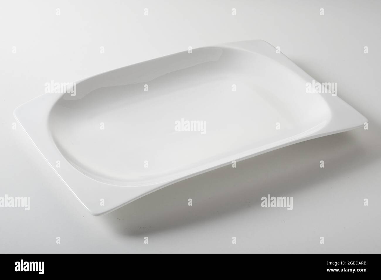 From above of clean empty rectangular plate placed on white background ...