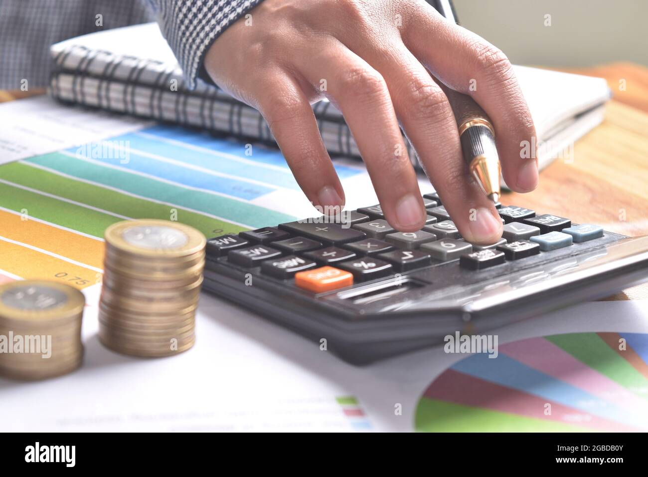 Hand Calculating Tax On Calculator at Office Stock Photo - Alamy