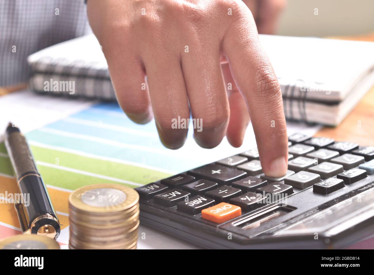 Doing Calculation On Calculator at the Office Stock Photo - Alamy