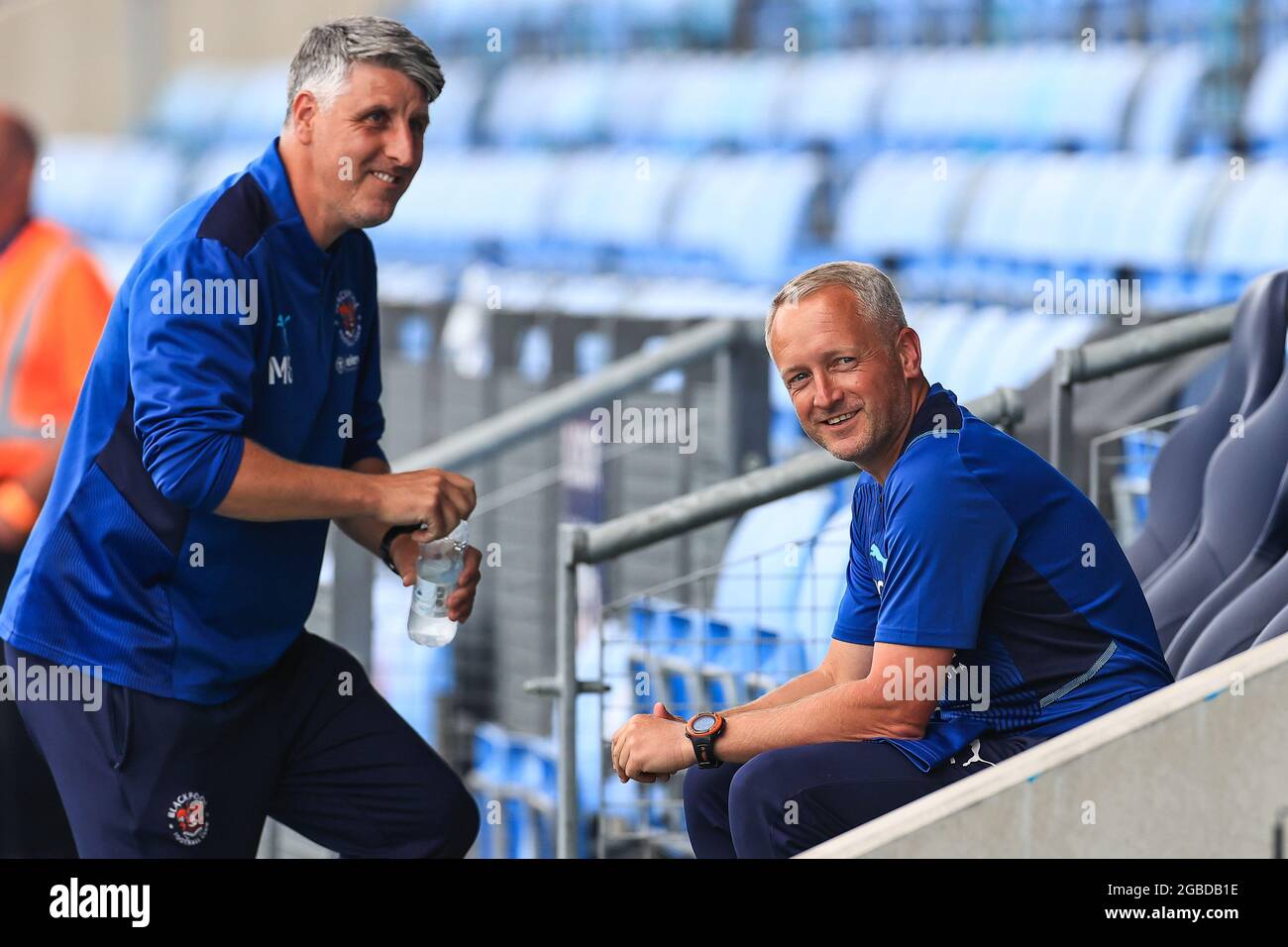 Neil Critchley manager of Blackpool glance across to the Manchester ...